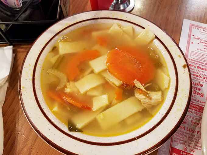 That golden broth with thick kluski noodles is the kind of soup that fixes things you didn't know were broken.