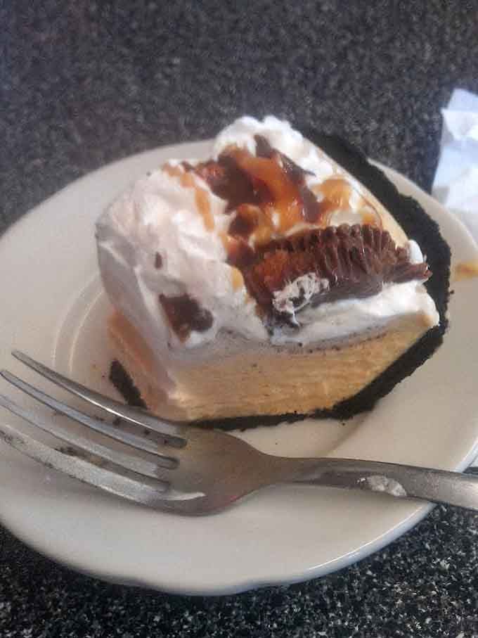 Peanut butter pie with whipped cream, caramel drizzle, and Reese's cups on top. Dessert just raised the stakes considerably.