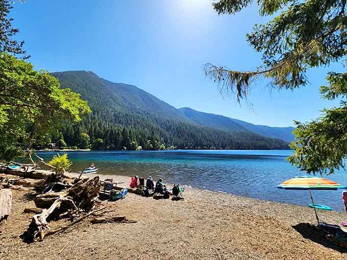 Rocky shores, beach umbrellas, mountain backdrop. Lake Crescent's recreational area is the Pacific Northwest's best-kept open secret.