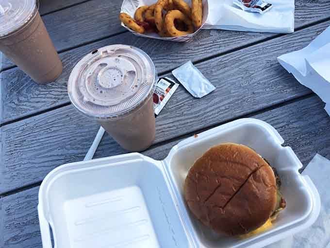 Burgers, onion rings, and thick chocolate malts on a picnic table, this is what a good afternoon looks like.