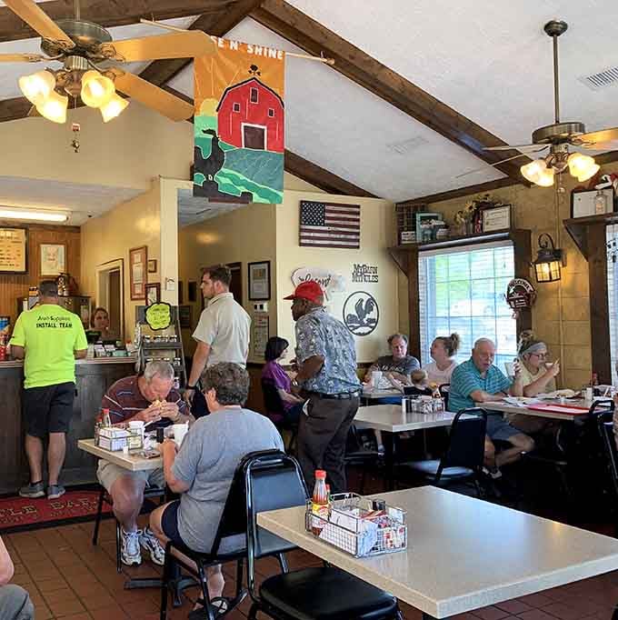 Locals gather around simple tables, sharing meals and conversation in true community diner fashion every morning.