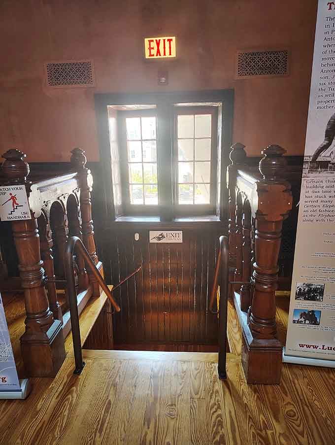 The central staircase spirals upward through Lucy's interior, a wooden passage through 140 years of quirky American history.