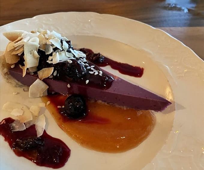 That cheesecake with berry compote is the kind of dessert that makes you reconsider your "I'm too full" declaration.