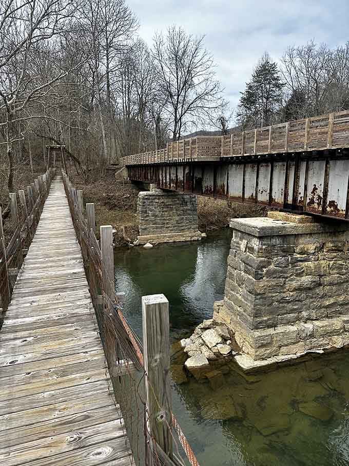 Standing on the swinging bridge with the old railroad trestle right beside you feels like two eras shaking hands.