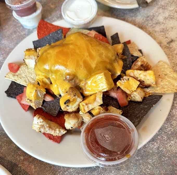 Blackened chicken nachos smothered in melted cheese with salsa on the side, this appetizer means serious business.
