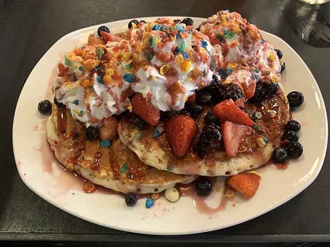 Fruity Pebbles, fresh berries, whipped cream, and pancakes. This stack is basically a celebration wearing breakfast as a costume.