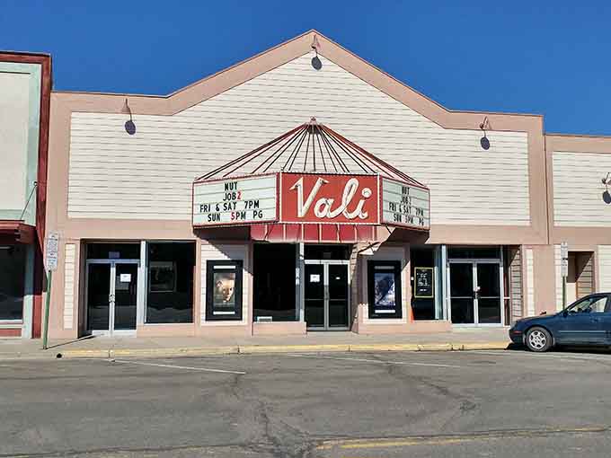 The Vali Theatre's classic marquee sign glows with small-town charm, the kind of movie house that makes you want to buy popcorn immediately.