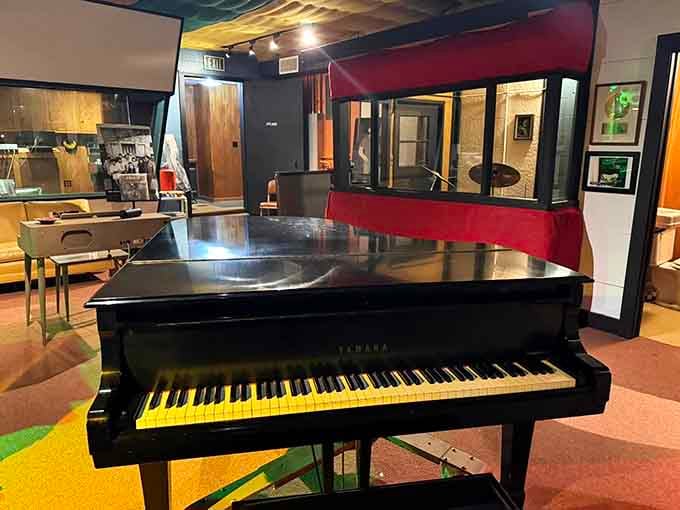 A Yamaha grand piano sitting in the live room, patient and ready, like it's still waiting for the next great session.