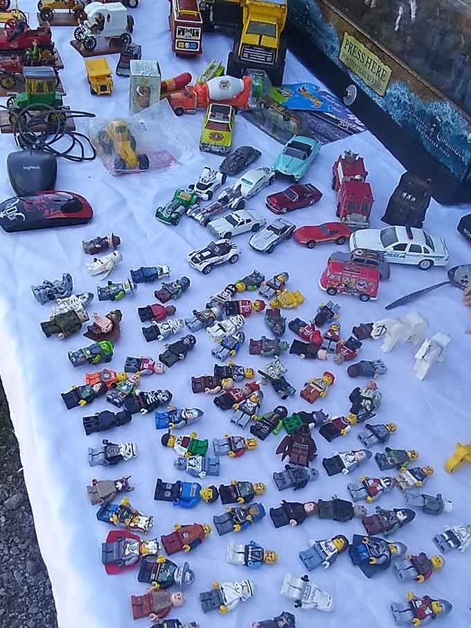 Dozens of tiny Lego figures and vintage die-cast cars spread out like a childhood memory you can actually hold again.