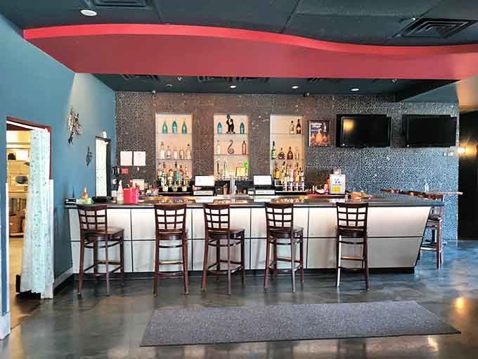 A full bar with sparkling tile, good lighting, and serious bottle selection. The evening's second act starts right here.