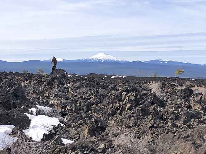 Hikers look like tiny dots crossing the ancient lava fields, which puts the volcano's true scale into perspective.