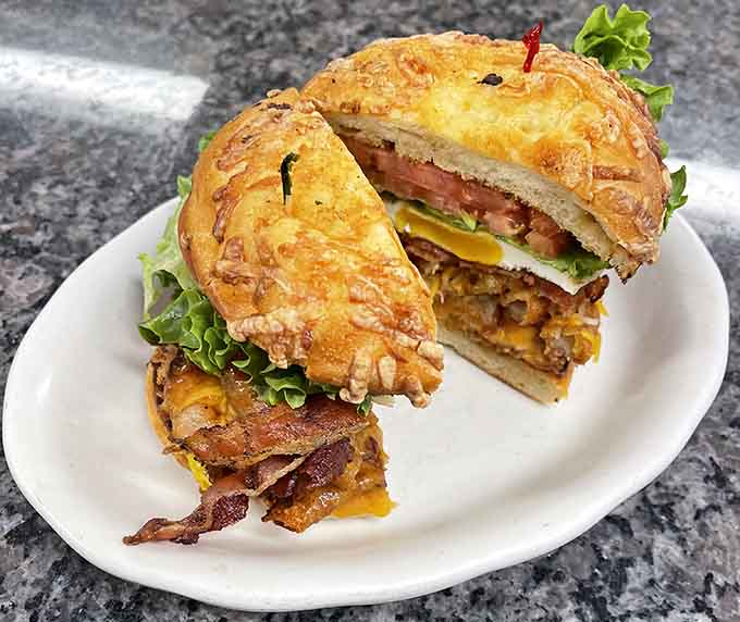 Layers of bacon, egg, cheese, lettuce, and tomato stacked inside a toasted roll. This sandwich means serious business.