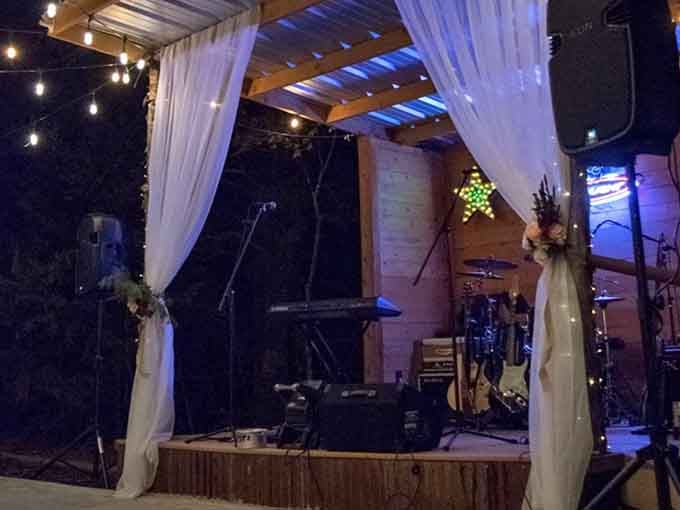 An outdoor stage draped in white fabric sets the scene for evenings filled with music and memories.