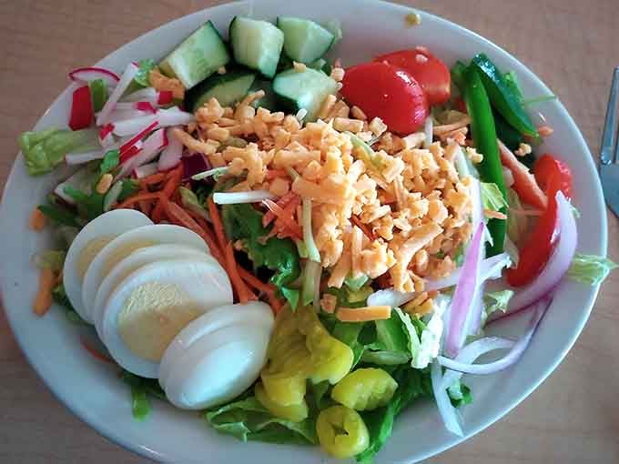 A garden's worth of fresh vegetables, shredded cheddar, and sliced hard-boiled eggs piled high, this salad means serious business.
