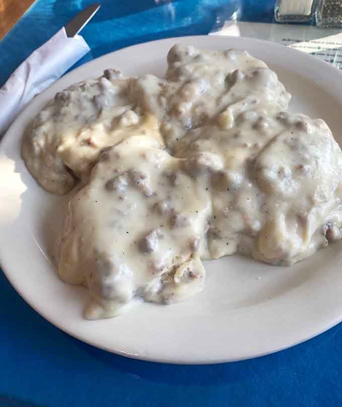 Biscuits and gravy so generously sauced you'll need a moment to appreciate the commitment happening on that plate.