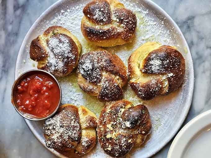 Golden, garlicky, dusted with Parmesan, and served with marinara. These knots are the reason you arrive hungry and leave happy.