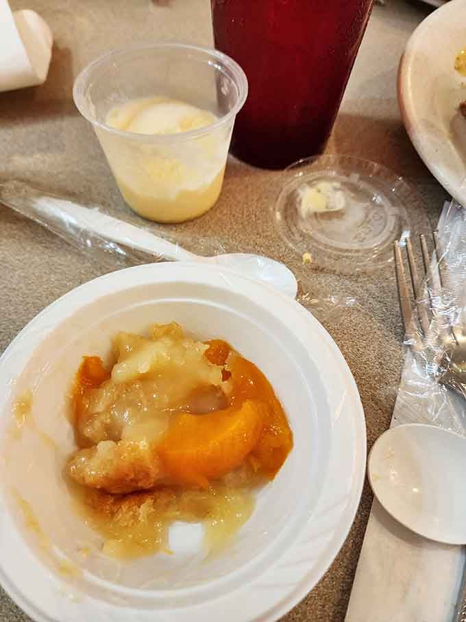 Peach cobbler that looks like sunshine in a bowl, ready to complete your buffet journey beautifully.