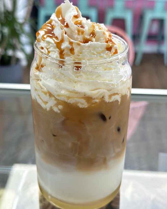 Caramel swirls through cold coffee like a delicious tornado, topped with enough whipped cream to matter.