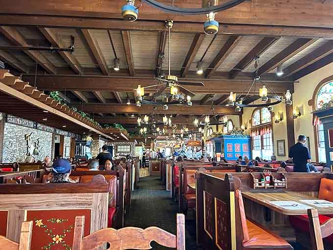 Warm wooden booths, glowing pendant lights, and stained glass windows make this dining room feel like a well-loved neighborhood secret.