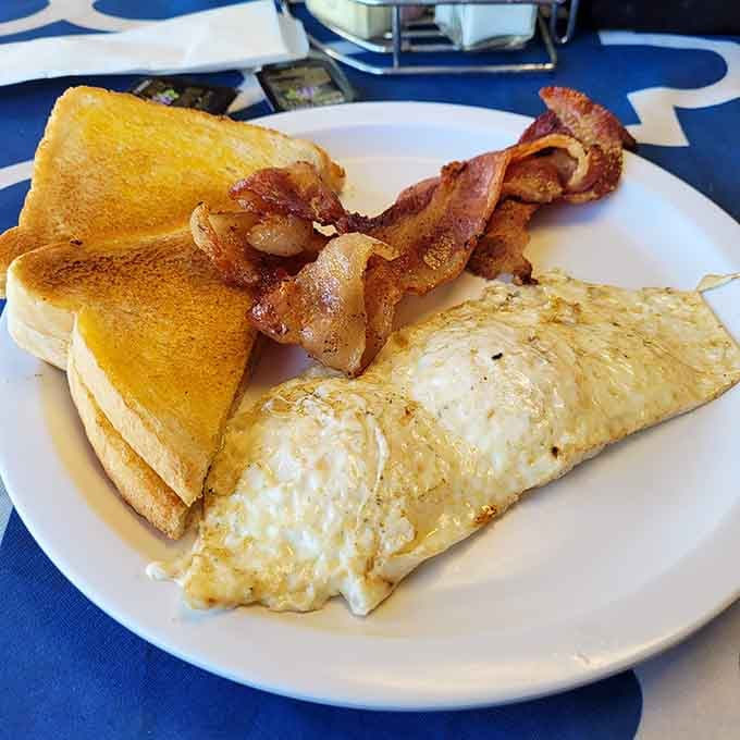 Fluffy omelet, crispy bacon strips, and golden toast. A plate that makes mornings worth waking up for.