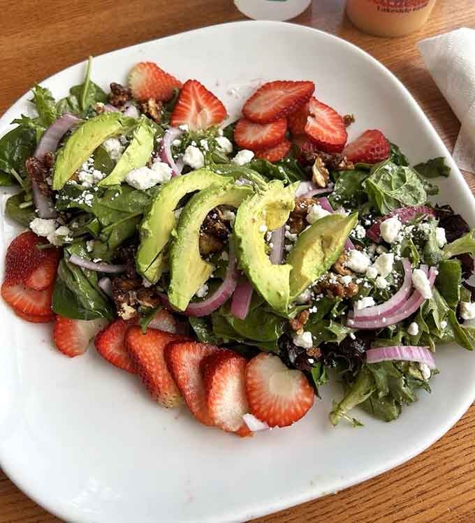 Strawberries, avocado, goat cheese, and greens, this salad at Redhead is proof that eating well can also be beautiful.