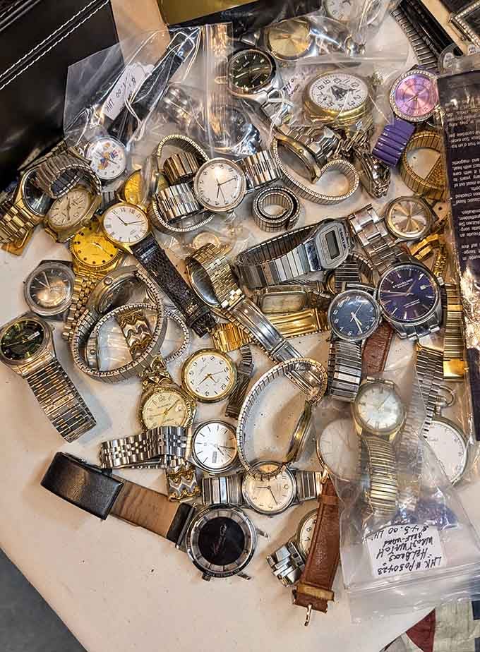Dozens of wristwatches spread across a table, each one a tiny, ticking chapter from somebody else's life story.