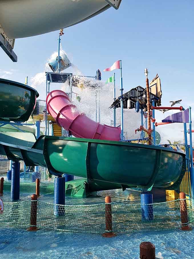 A massive bucket tips, water crashes down, and nobody within ten feet escapes dry, which is entirely the point.