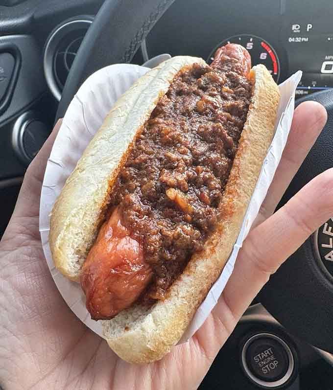 That chili-loaded Ripper, held in someone's hand outside, is proof that the best meals don't need a dining room.