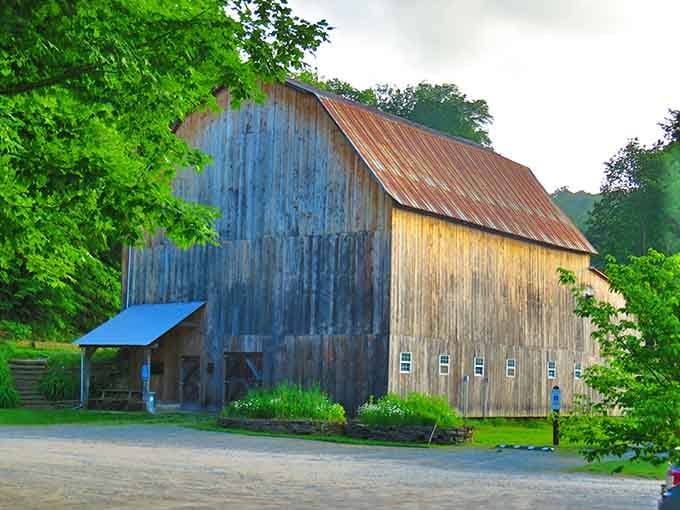 That weathered old barn has seen more sunrises than most of us ever will, and it's still standing proud.