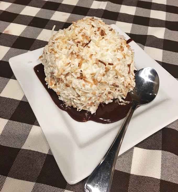 The Toasted Coconut Snowball sitting in chocolate sauce is the dessert that makes you forget you were full.