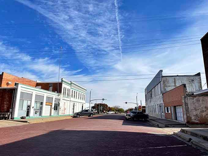 Shamrock's brick-paved intersection sits quietly under dramatic cloud-streaked skies, looking like a painting someone forgot to finish.
