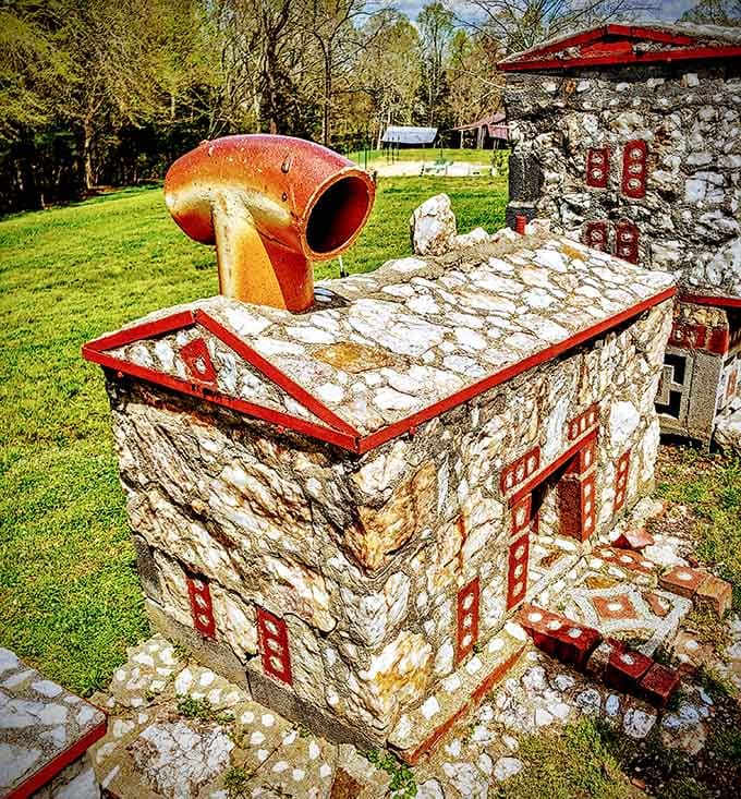 That oversized rusty pipe chimney sitting on a perfectly crafted stone roof is pure, unfiltered creative genius.