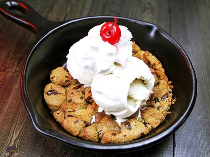 The Kookie Monster skillet cookie arrives warm, loaded with ice cream, and completely unapologetic about it.