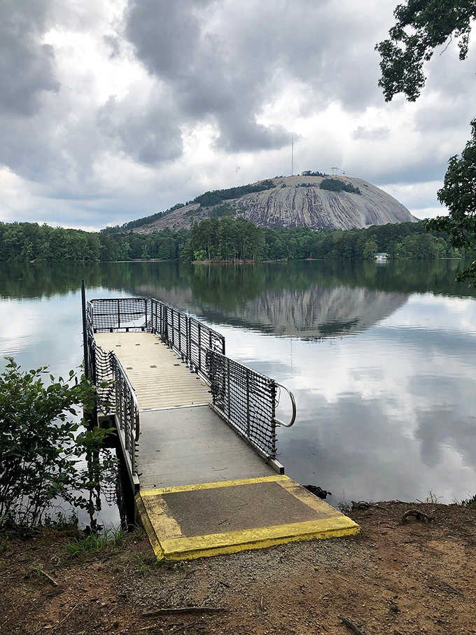 The fishing dock extends into calm waters where patience is rewarded and stress simply floats away with the current.