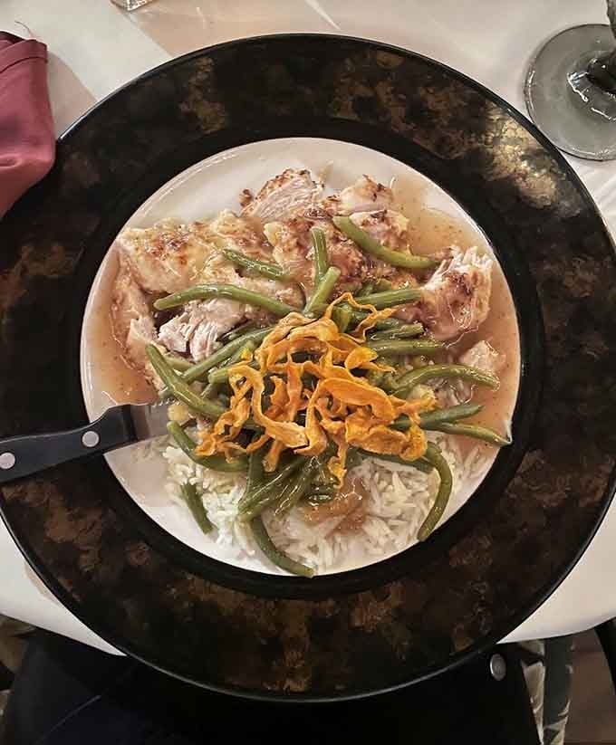 Chicken Arabesque over rice with green beans and crispy carrot strings, comfort food dressed up for a special occasion.