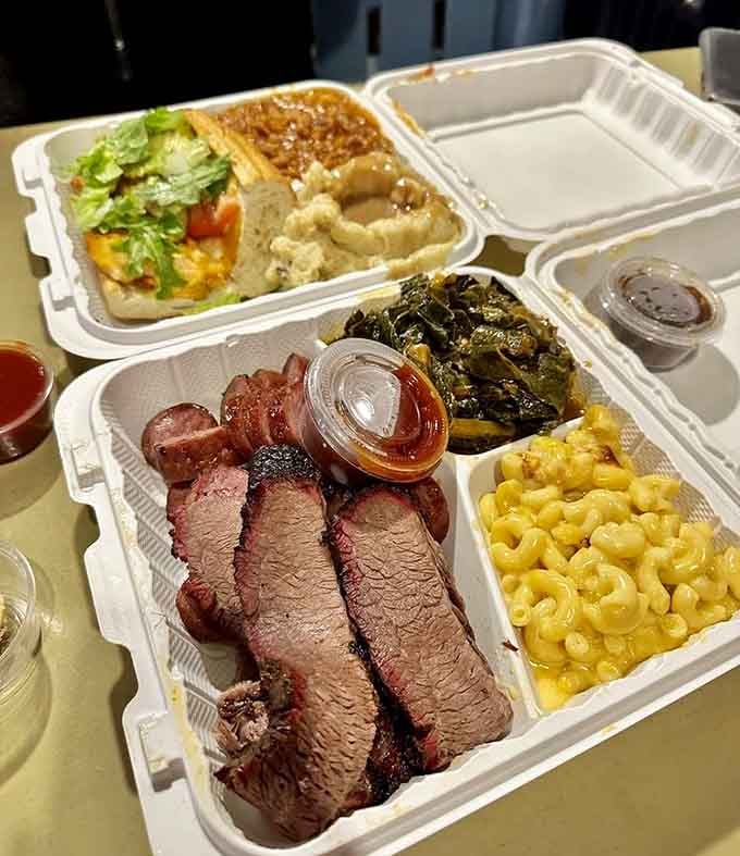 Sliced brisket with that gorgeous smoke ring, sitting next to collard greens and mac and cheese. This is the full picture.