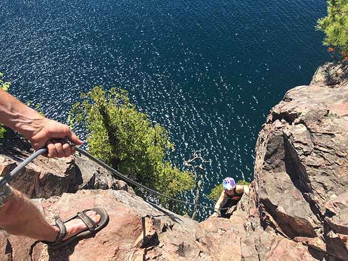 Gripping ancient red volcanic rock with Lake Superior sparkling far below, this is Minnesota adventure at its most thrillingly vertical.