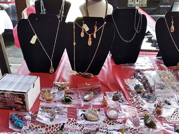 Delicate wire-wrapped stones and elegant pendant necklaces displayed on velvet stands, someone clearly put their whole heart into this jewelry table.