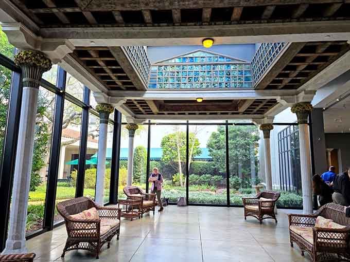 Wicker chairs, columned ceilings, and a Tiffany glass skylight overhead, this sun-drenched gallery corridor is the most civilized place to catch your breath.
