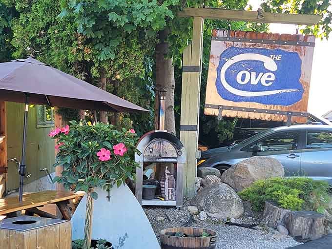 Weathered signage framed by pink petunias announces you've arrived at your new favorite waterfront spot.
