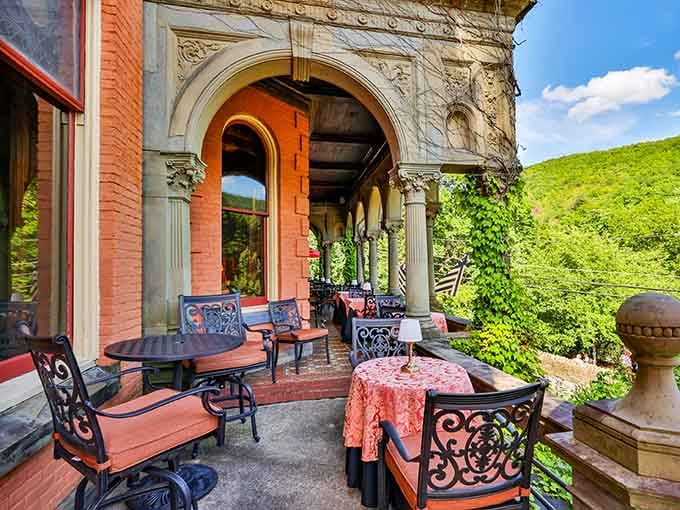 Stone arches, iron furniture, and mountain views stretching out in every direction. This porch is basically an outdoor living room with better scenery.