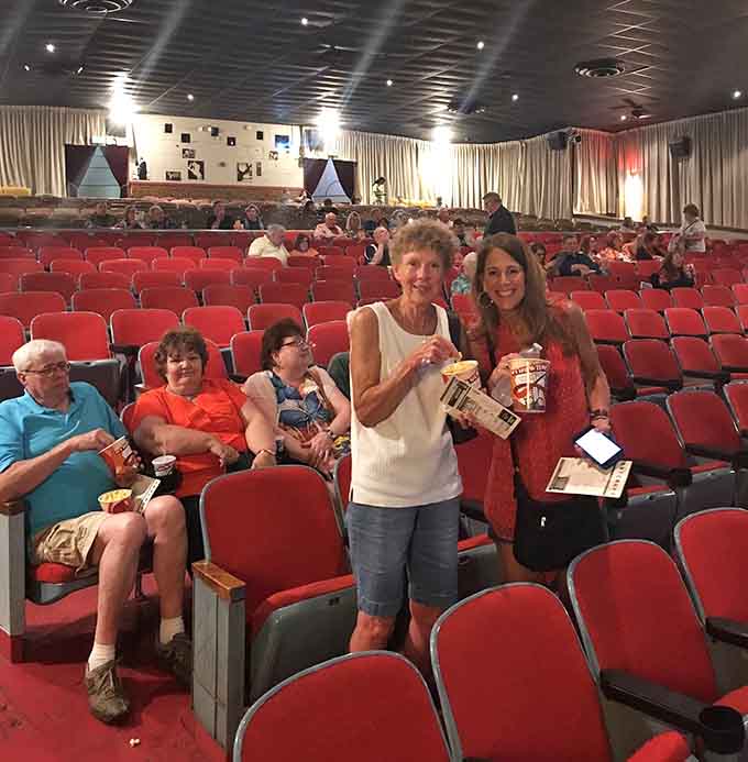 Happy faces, big buckets of popcorn, and red velvet seats, this is what a good night out looks like.