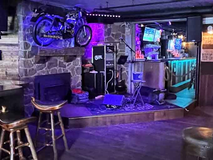 The stage area bathed in purple light where live music brings modern energy to these centuries-old walls nightly.
