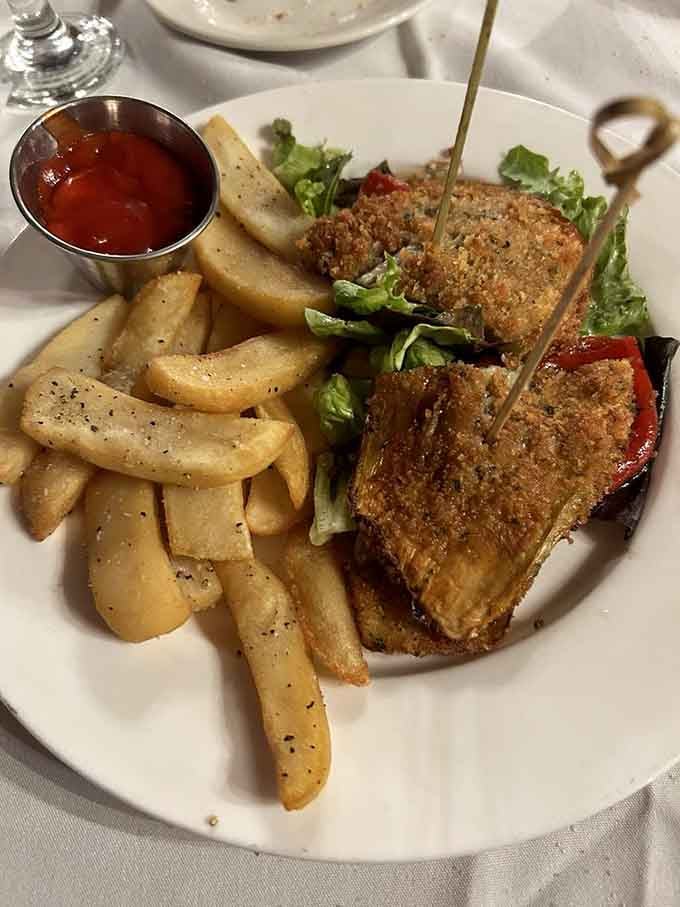 The breadless eggplant sandwich arrives golden, crispy, and proud. Even the french fries look excited to be on this plate.
