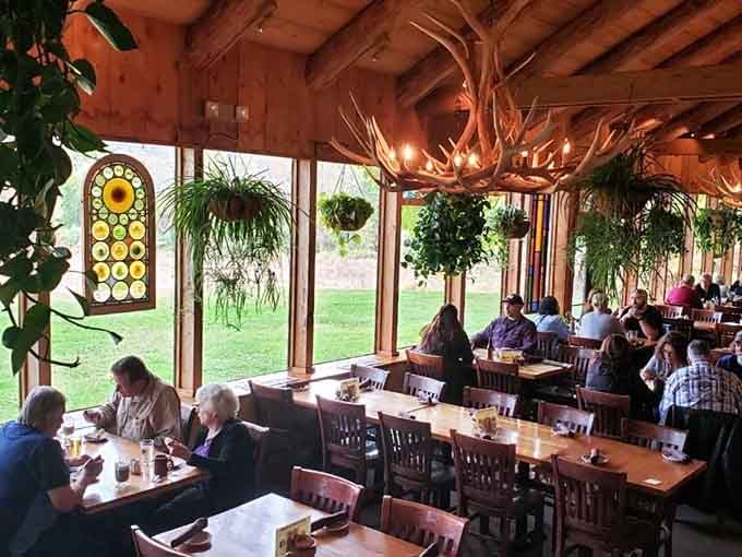 The greenhouse dining room brings the outdoors in, with hanging ferns creating a garden party atmosphere year-round.