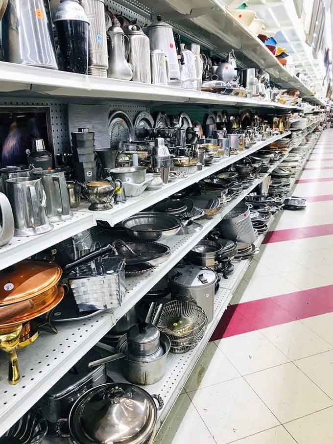 An entire aisle of cookware, silverware, and metalware so extensive it could outfit a small restaurant with ease.