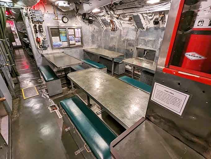 Steel tables, green benches, and walls packed with history: the crew's mess where ordinary meals happened in extraordinary circumstances.
