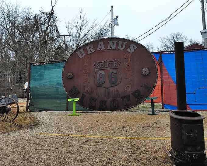 A massive Route 66 belt buckle sign that screams Missouri pride from every weathered, rust-kissed inch of it.