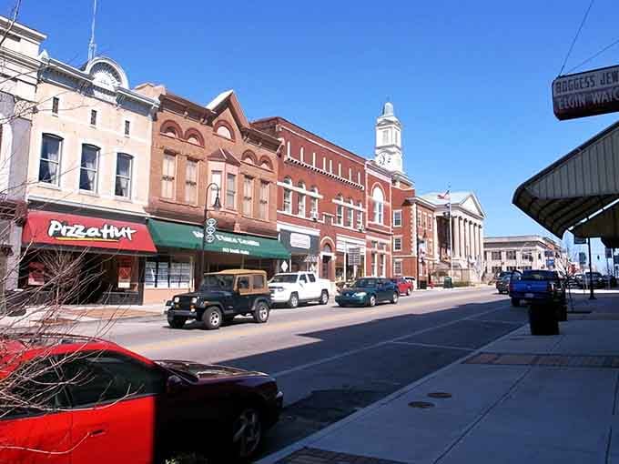 Main Street Versailles unfolds past red brick storefronts that have watched over a century of everyday stories.