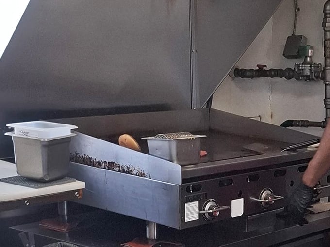The flat-top grill where burger magic happens, sizzling away like it has for nearly 65 glorious years.